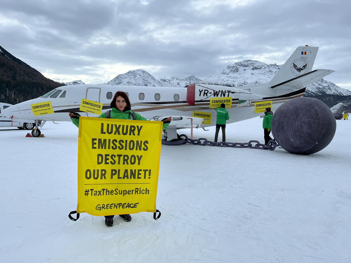 Greenpeace protestors urge leaders at World Economic Forum to tax the ...